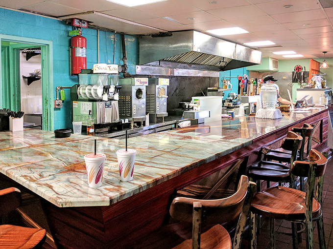 The marble counter and turquoise walls create the perfect Louisiana vibe&mdash;casual elegance with a side of "come on in and stay awhile."