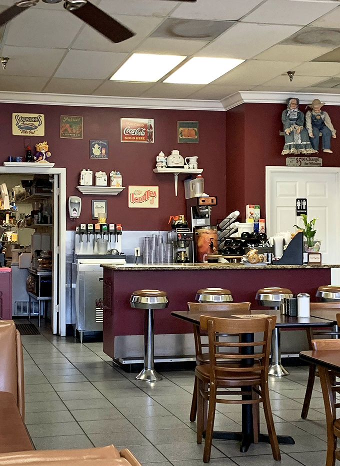 Vintage signs and whimsical teapots adorn burgundy walls &ndash; not because a designer said so, but because someone actually loves these things.