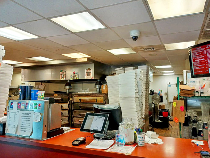 A glimpse behind the curtain&mdash;where pizza magic happens. Those stacked boxes aren't just containers; they're vessels of joy awaiting deployment to hungry patrons.