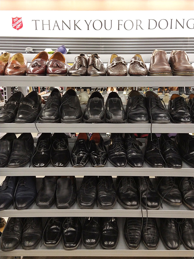 Men's shoes stand at attention under a "Thank You" banner, a reminder that every purchase supports programs helping Nevada's most vulnerable residents.