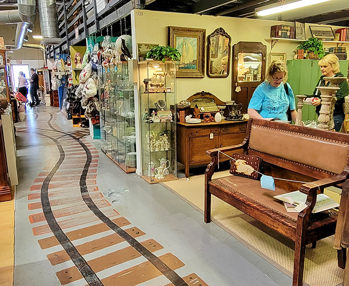 The curved pathway guides shoppers through vendor booths like a yellow brick road of nostalgia, with treasures beckoning from every direction.