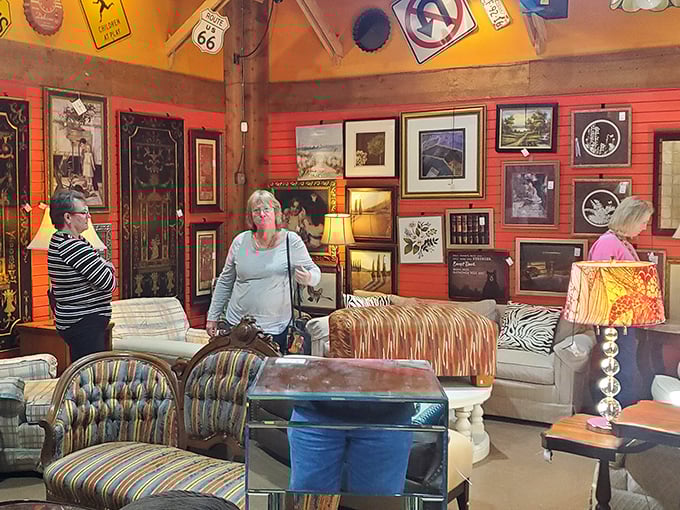 The thrill of the hunt captured &ndash; shoppers navigate a sea of furniture and framed art in this colorful treasure-filled corner.