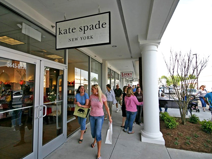 Kate Spade's storefront welcomes shoppers who've mastered the art of looking expensive while being secretly, brilliantly thrifty.