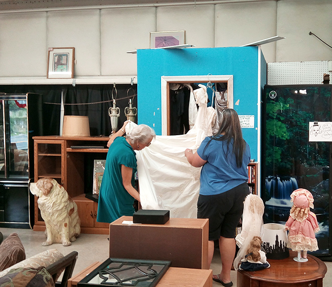 Volunteers bringing order to the beautiful chaos. Even the patient pup knows the joy of finding the perfect secondhand treasure.