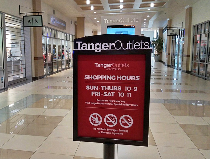 The shopping hours sign lays down the law: No alcohol allowed. Your credit card is intoxicating enough in this environment.