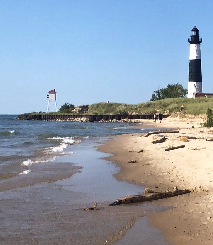 Where lake meets land, the lighthouse keeps its eternal watch. Those gentle waves belie Lake Michigan's reputation for sudden, ship-swallowing storms.