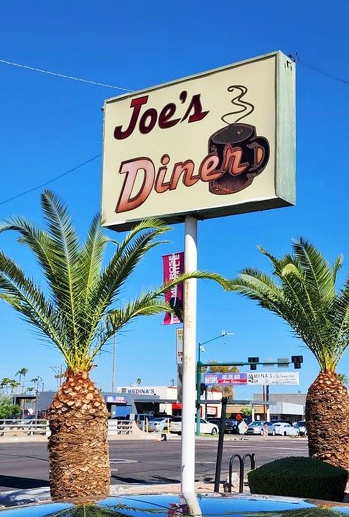 The sign stands tall among palm trees, a beacon of breakfast hope in a sea of chain restaurants and green smoothie shops.
