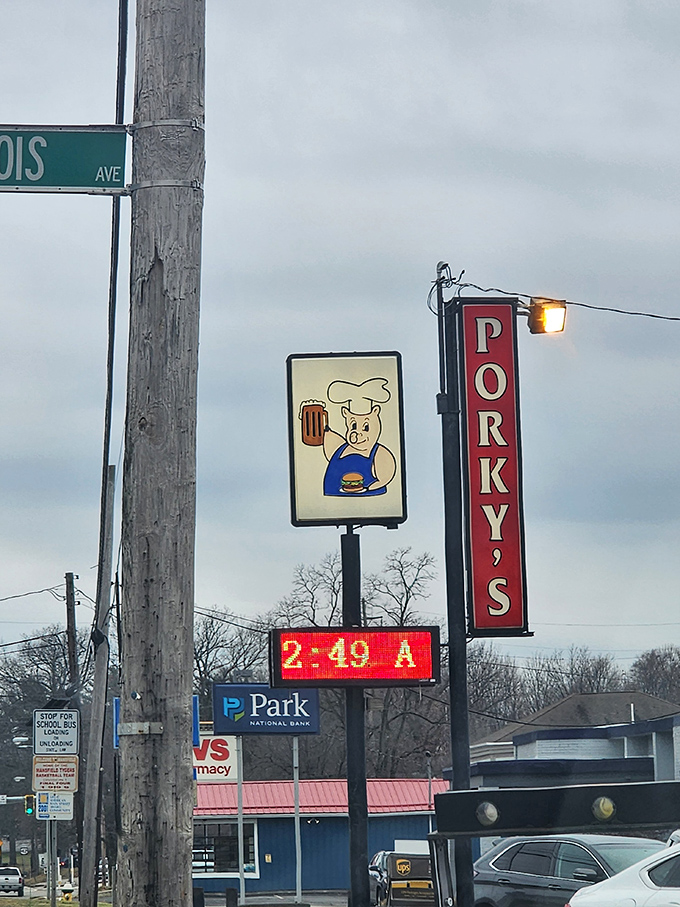 The vintage sign featuring a cartoon chef pig holding a burger tells you everything you need to know.
