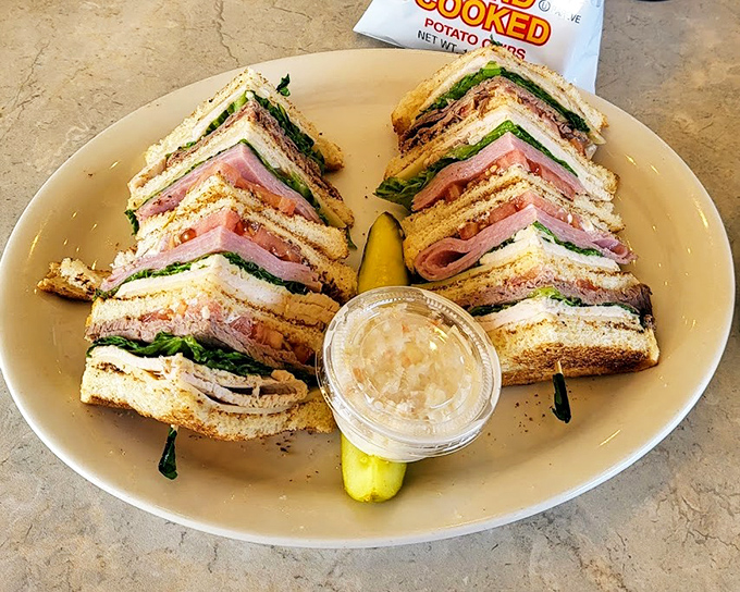 The club sandwich&mdash;architecture you can eat! Layered with such precision that Frank Lloyd Wright would approve. The pickle stands guard.