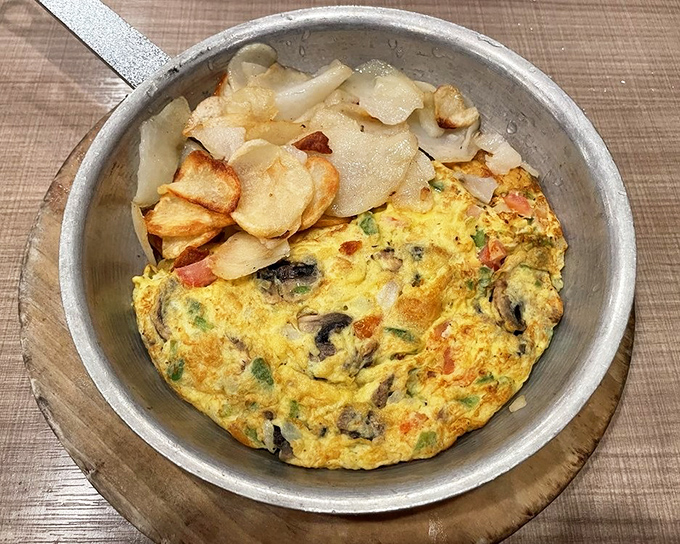 This veggie-packed omelet isn't just breakfast&mdash;it's practically a garden tour served in a skillet with crispy potatoes as your tour guide.