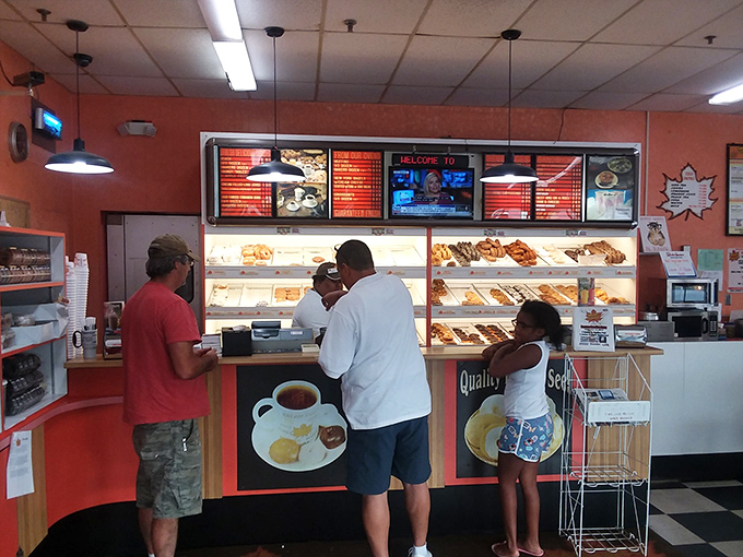 Decision time at the donut counter. That neon "VARIETIES" sign isn't kidding&mdash;choice paralysis is a real condition here.