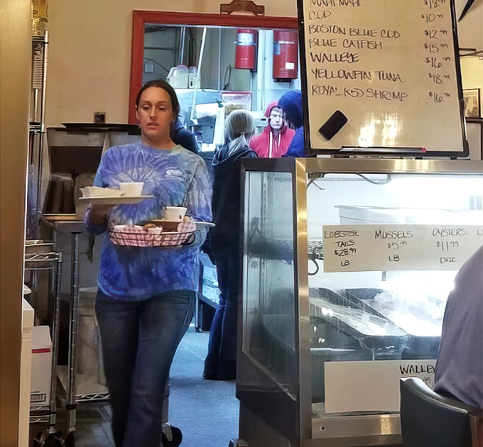 Behind every great seafood dish is a dedicated team member carrying plates like precious cargo. The real MVPs of your dining experience.