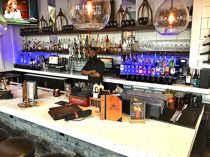 The bar area glows with possibility. Those illuminated bottles aren't just spirits&mdash;they're conversation starters waiting to happen. 