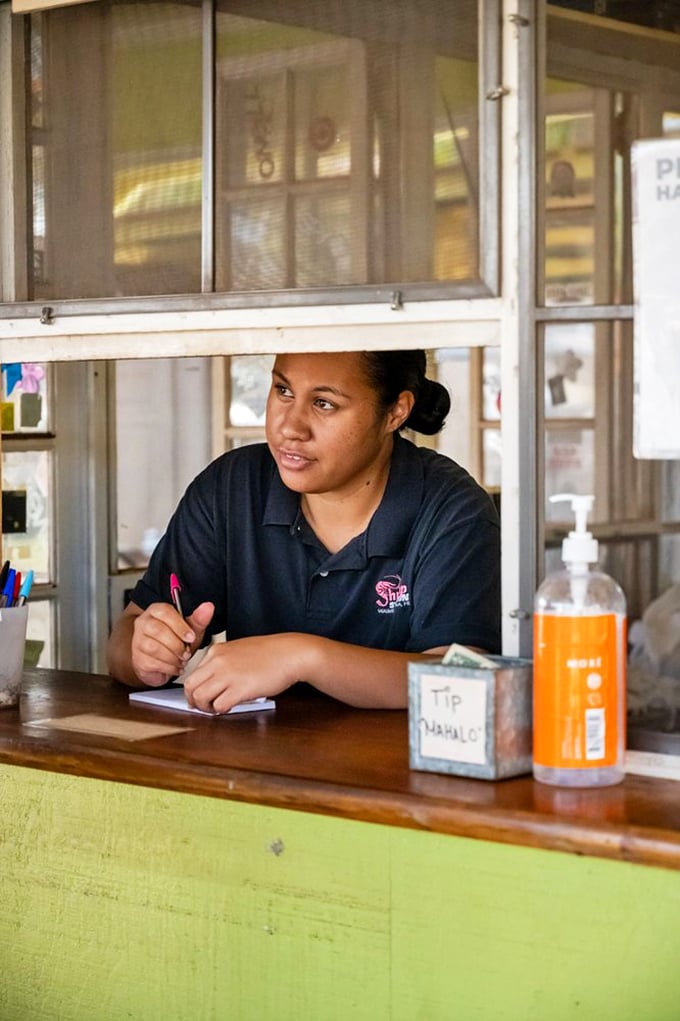 Taking orders with the calm efficiency of someone who knows they're about to make your day significantly better.