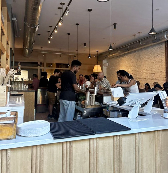 Where pizza magic happens &ndash; skilled hands transform simple ingredients into transcendent pies while diners watch in reverent anticipation.