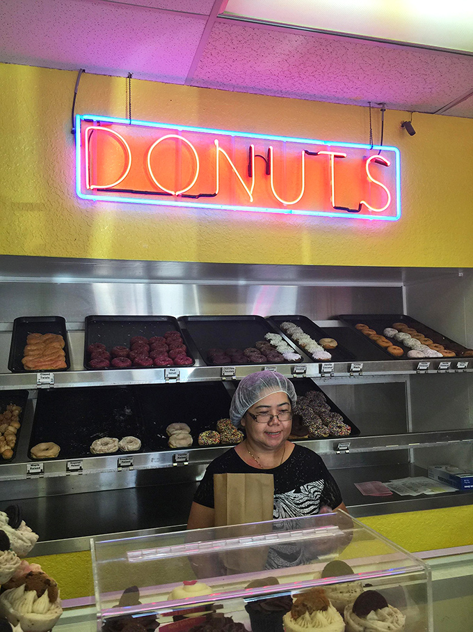 Behind every great donut is a dedicated artisan, crafting joy one pastry at a time under the glow of that iconic neon sign.