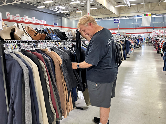 The thrill of the hunt captured in real-time. This shopper examines each garment with the careful consideration of a diamond appraiser&mdash;because sometimes, that's exactly what he is.