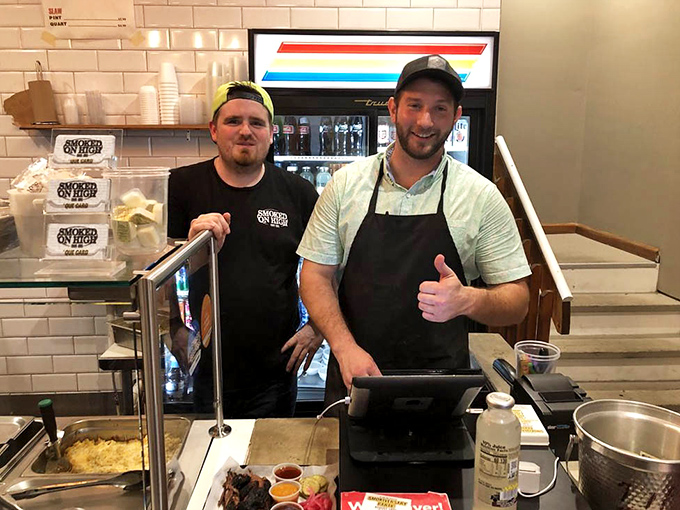 The pitmasters behind the magic, giving a thumbs-up that says, "Yes, we know what we've done to your taste buds, and we're not sorry."