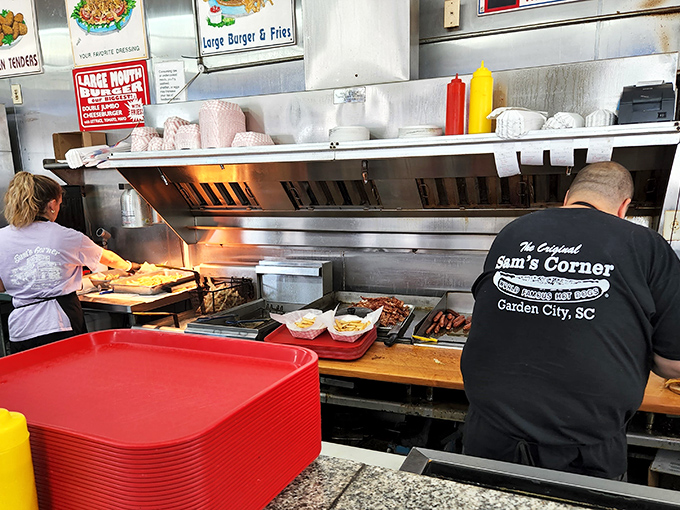 Behind every great burger joint is a dedicated team. The back-of-house crew works their magic while wearing the restaurant's signature black tees.