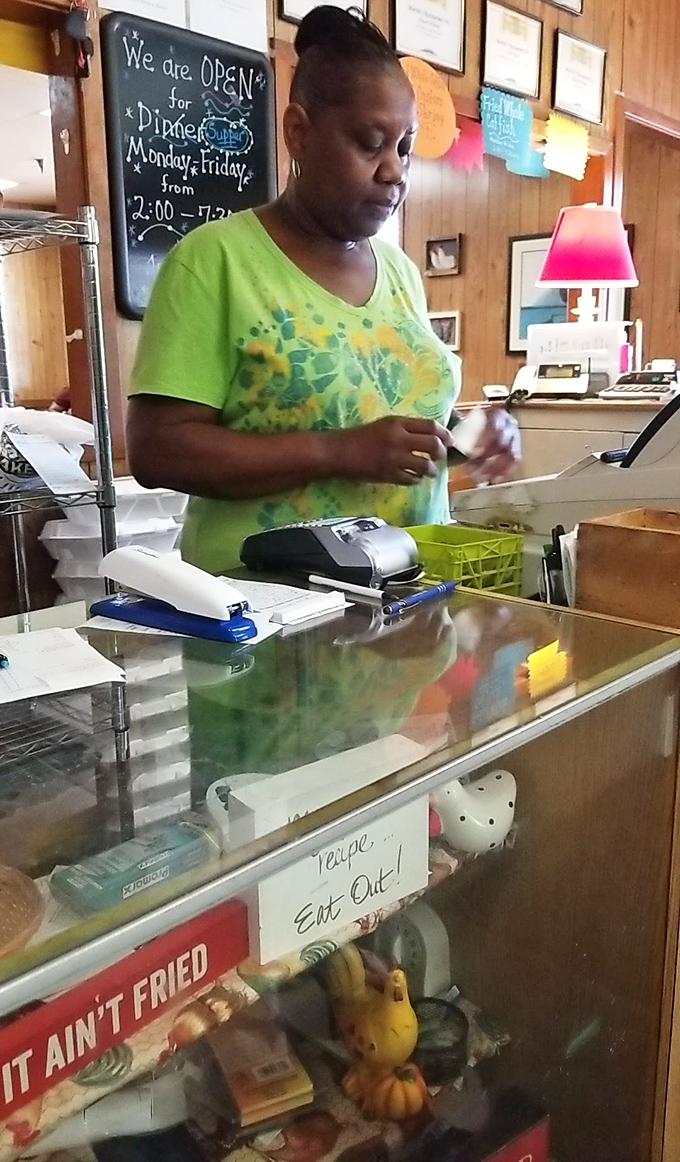 Behind every great restaurant is a dedicated staff making the magic happen. The sign says it all: "People... Eat Out!"