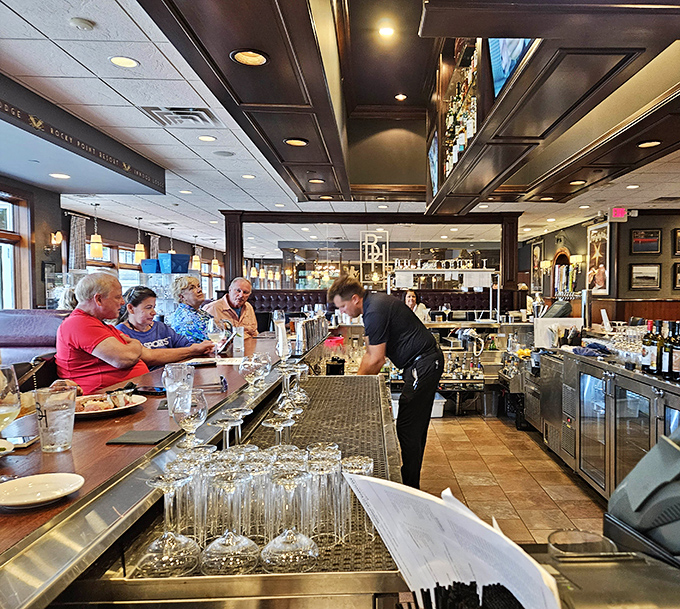 Staff attending to patrons at the bar&mdash;the unsung heroes who know exactly when you need another round without being asked.
