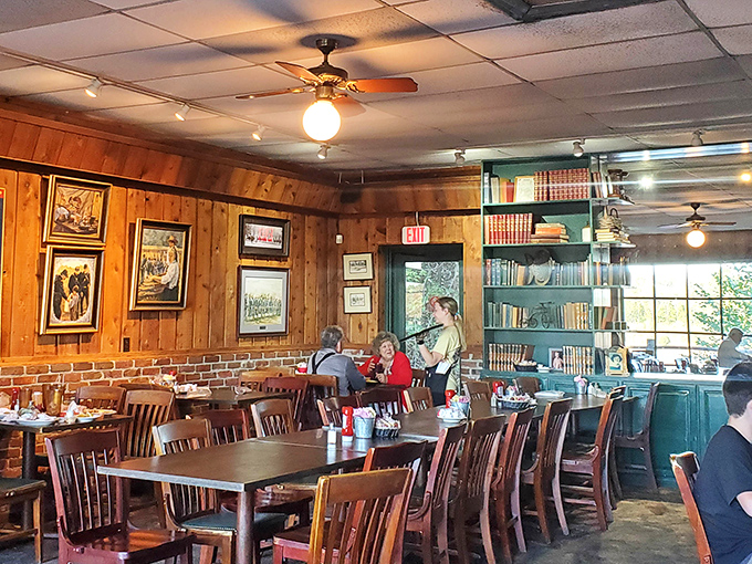The host stand welcomes you like an old friend, while framed photographs on pine walls whisper tales of riverside meals past.