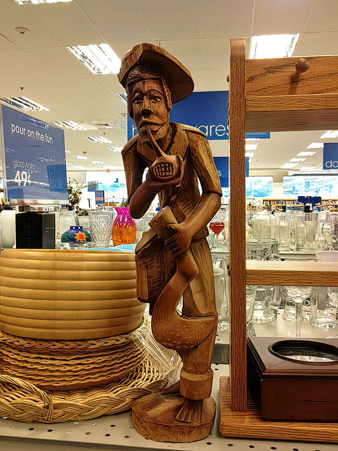 This wooden figure stands sentinel among the glassware, a conversation piece waiting for its next dinner party debut.