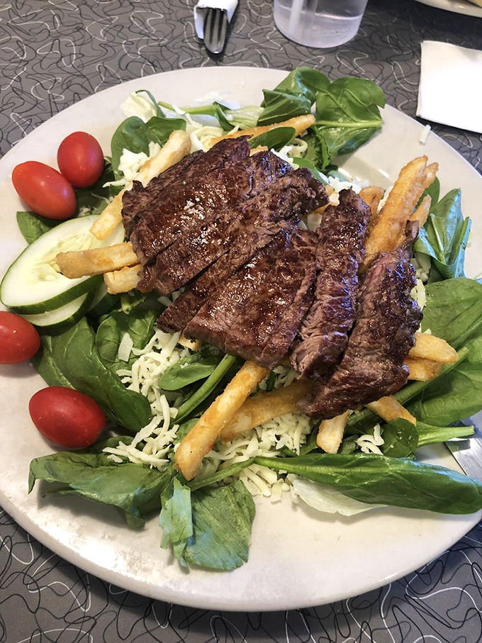 A steak salad that respects both the meat and the greens. Those fries crashed the health party, and nobody's complaining.