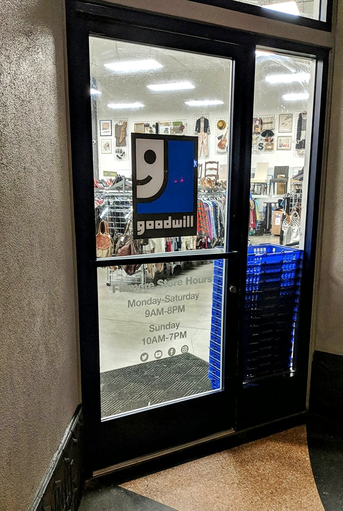 The welcoming entrance displays store hours and the smiling Goodwill logo&mdash;a portal to affordable possibilities seven days a week.