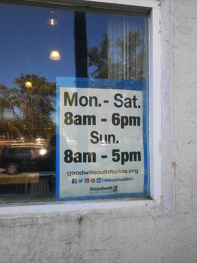 The fine print of bargain hunting. Store hours posted clearly for those who plan their thrifting expeditions with military precision.