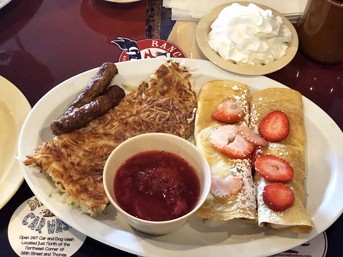 These crepes aren't just filled with strawberries&mdash;they're wearing them like jewelry, with a side of hash browns for balance.