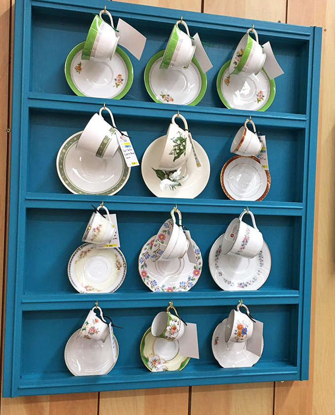 These teacup-and-saucer sets hanging on a turquoise display make afternoon tea suddenly seem like a lifestyle worth reconsidering entirely.