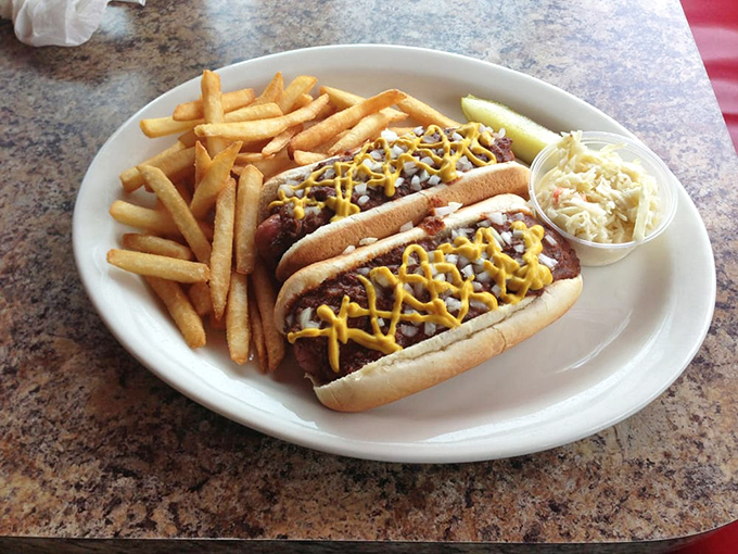Hot dogs dressed to impress with mustard zigzags and a side of fries. Proof that simple food done right is better than fancy food done wrong.
