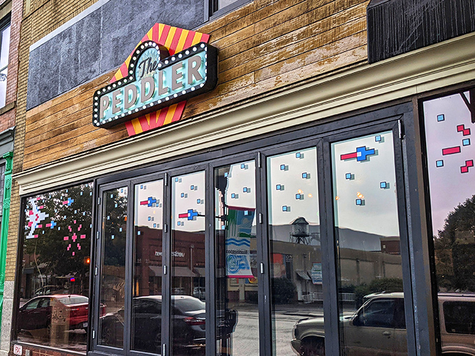 The Peddler's retro marquee sign glows with mid-century optimism. Behind those windows lies a dining experience that balances nostalgia with contemporary tastes.