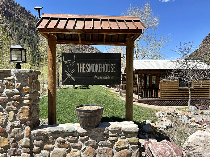 The Smokehouse sign stands as a beacon for barbecue pilgrims. Those mountains in the background? Just the appetizer to the main course inside.
