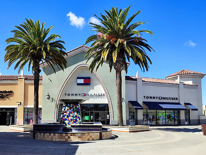 Tommy Hilfiger's distinctive arched entrance flanked by palm trees &ndash; architectural proof that shopping is indeed a religious experience.