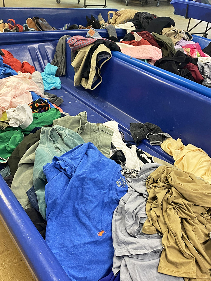 A textile tapestry of possibilities. Each layer might reveal that perfect t-shirt, vintage dress, or designer piece hiding in plain sight among everyday items.