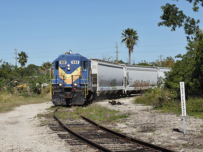 Engine 630 pulls its cargo through palm-lined tracks, a working reminder of how Florida's commerce moves when tourists aren't looking.