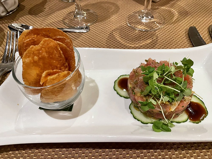 Tuna tartare presented with architectural precision, accompanied by house-made potato chips&mdash;a sophisticated starter that sets the tone for what's to come.