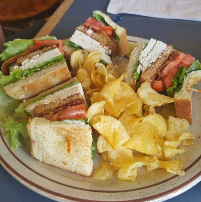 A club sandwich cut into perfect triangles with potato chips standing guard&mdash;the lunch equivalent of a warm hug on a plate.