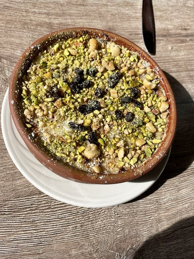 Umm Ali dessert topped with nuts and raisins - Egypt's answer to bread pudding perfection. 