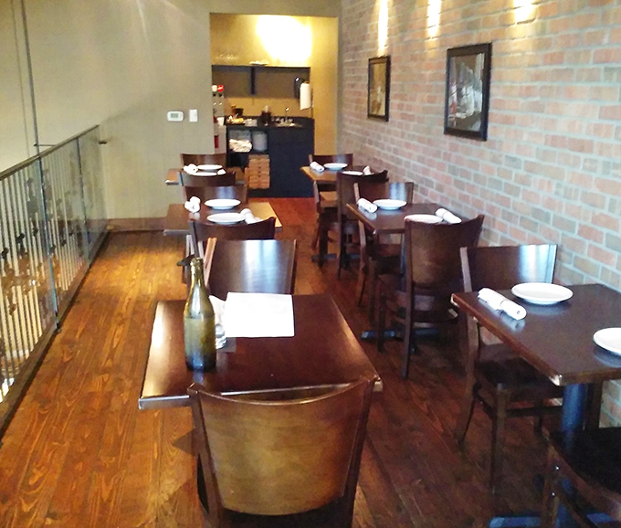 Upstairs seating offers the perfect perch for people-watching, with warm wood and exposed brick creating that "I've discovered something special" feeling.