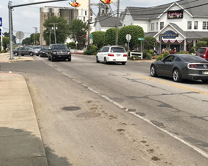 Horse-drawn buggies parked alongside modern cars create a visual timeline that spans centuries in a single downtown block.