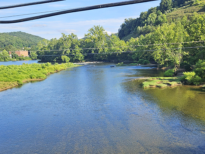 The view from the bridge offers a serene perspective of the Tygart Valley River, its waters reflecting the same sky that witnessed America's first land battle of the Civil War.