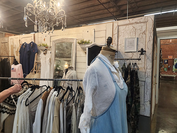 Vintage clothing displayed under crystal chandeliers&mdash;because even second-hand deserves first-class treatment. That mannequin has better posture than all of us.