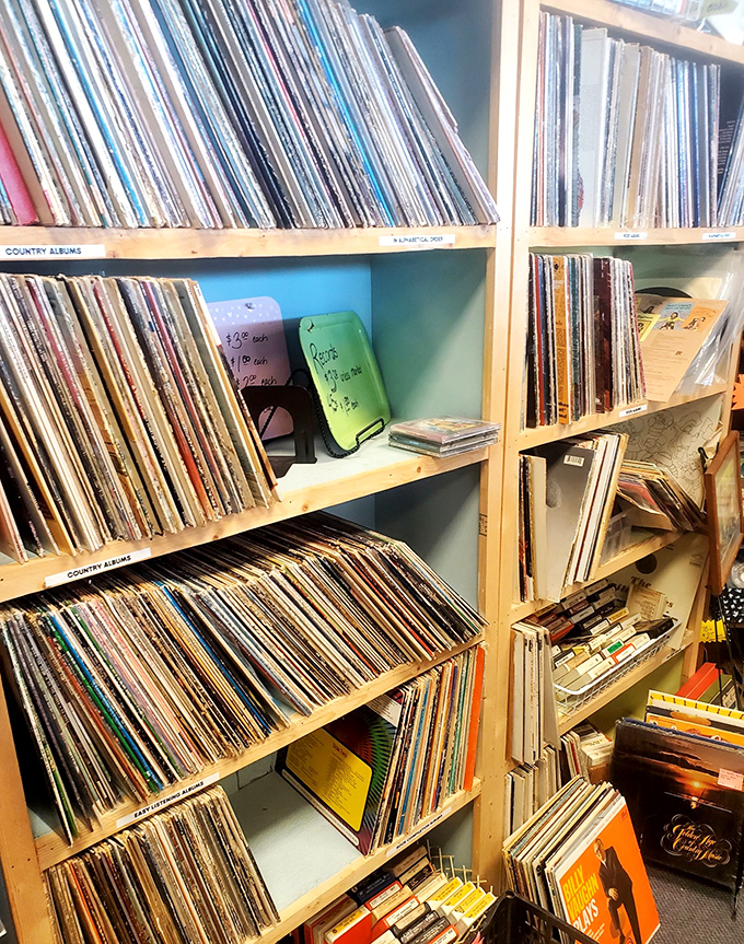 Vinyl records organized by genre&mdash;each album cover a mini time capsule of graphic design history. Country albums: where heartbreak sounds better with a little scratch and pop.