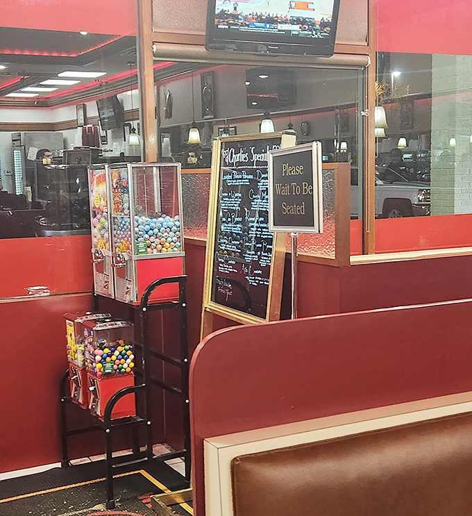 The waiting area features the universal language of "Please Wait To Be Seated" and the childhood joy of gumball machines. Some things never change, thankfully.