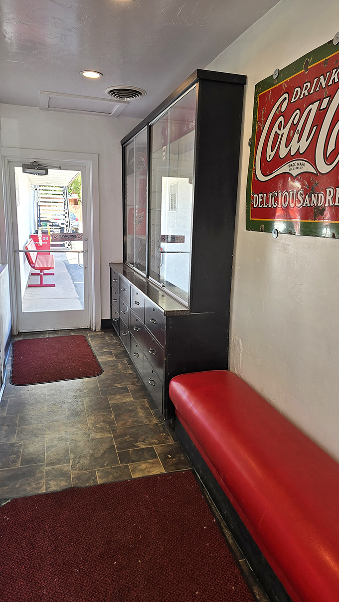 Even the waiting area tells a story&mdash;vintage Coca-Cola signs, red vinyl seating, and the anticipation of comfort food just steps away.