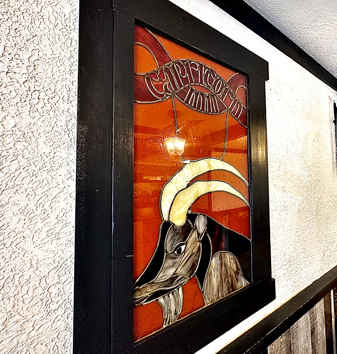 The stained glass Capricorn emblem serves as both zodiac nod and unofficial coat of arms for this beloved local institution.