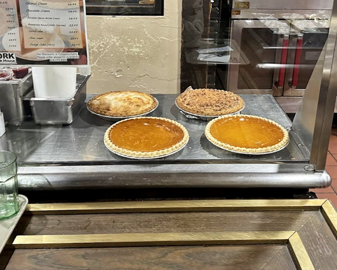 Homemade pies waiting patiently in their display case, each one promising to be the perfect finale to your steak house adventure.